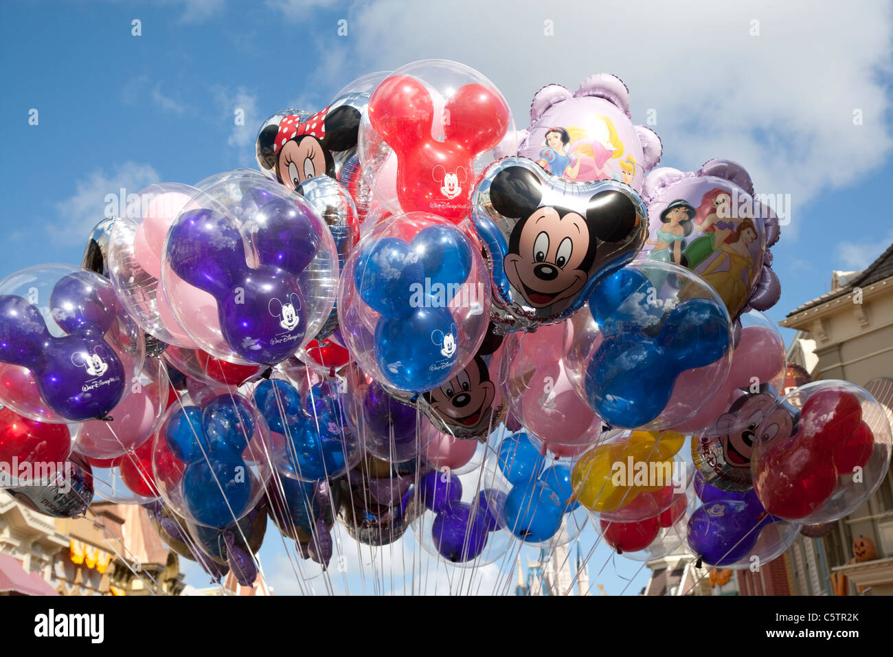 A bunch of Walt Disney themed helium balloons floating together ...