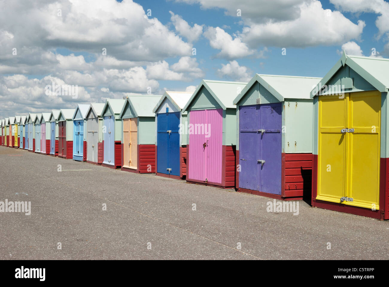 Colourful beach huts on seafront promenade at Hove. Brighton. East ...