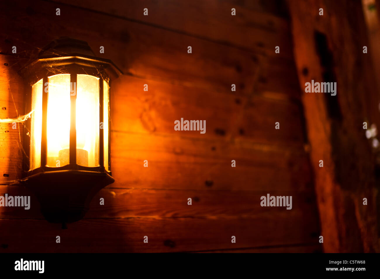 An illuminated lantern in a barn Stock Photo - Alamy