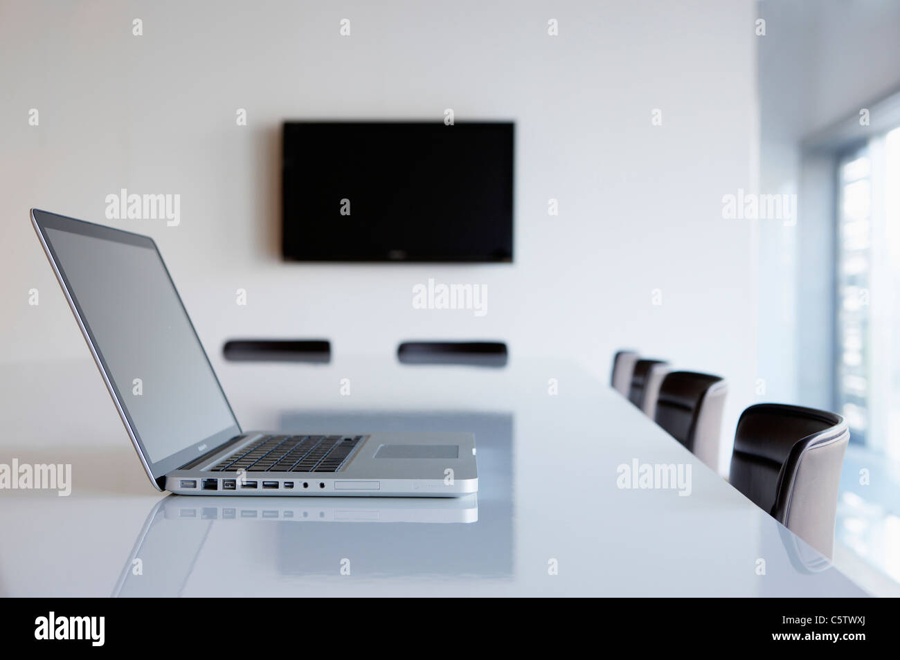 Laptop on table in conference room Stock Photo - Alamy