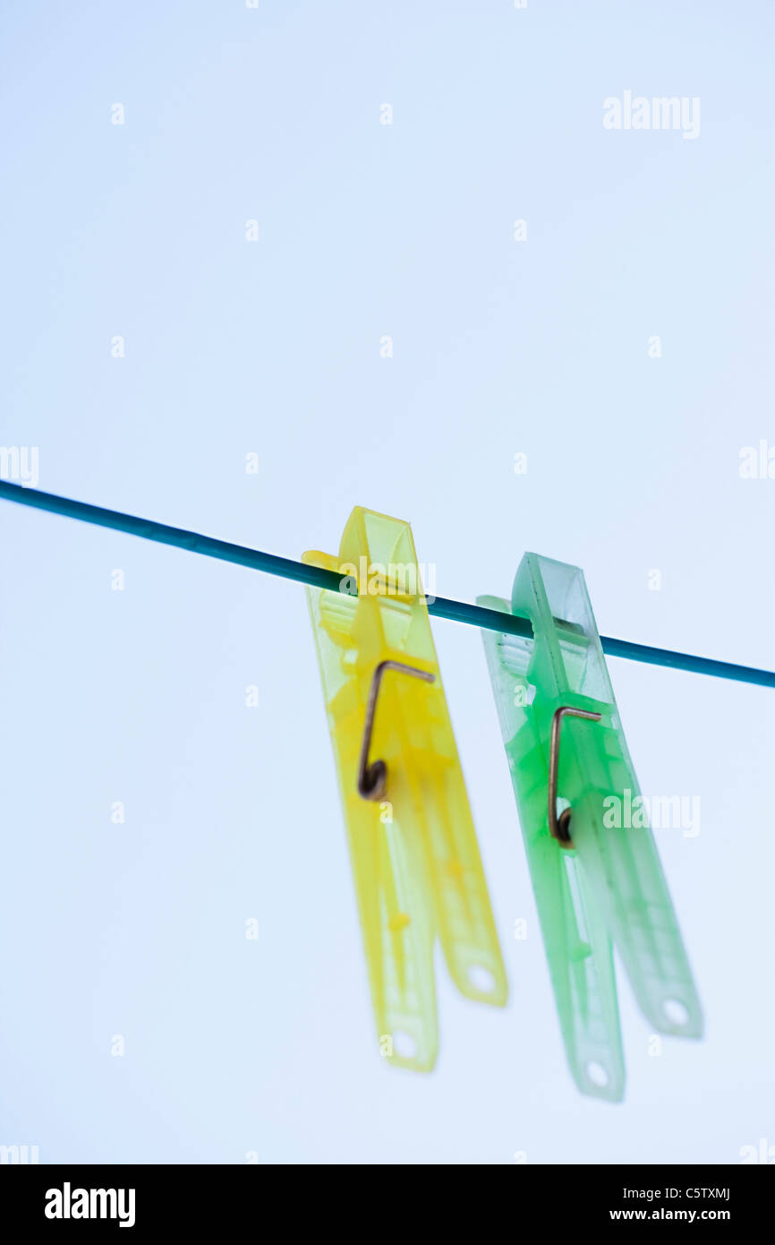 Clothes pegs on clothesline, close-up Stock Photo - Alamy