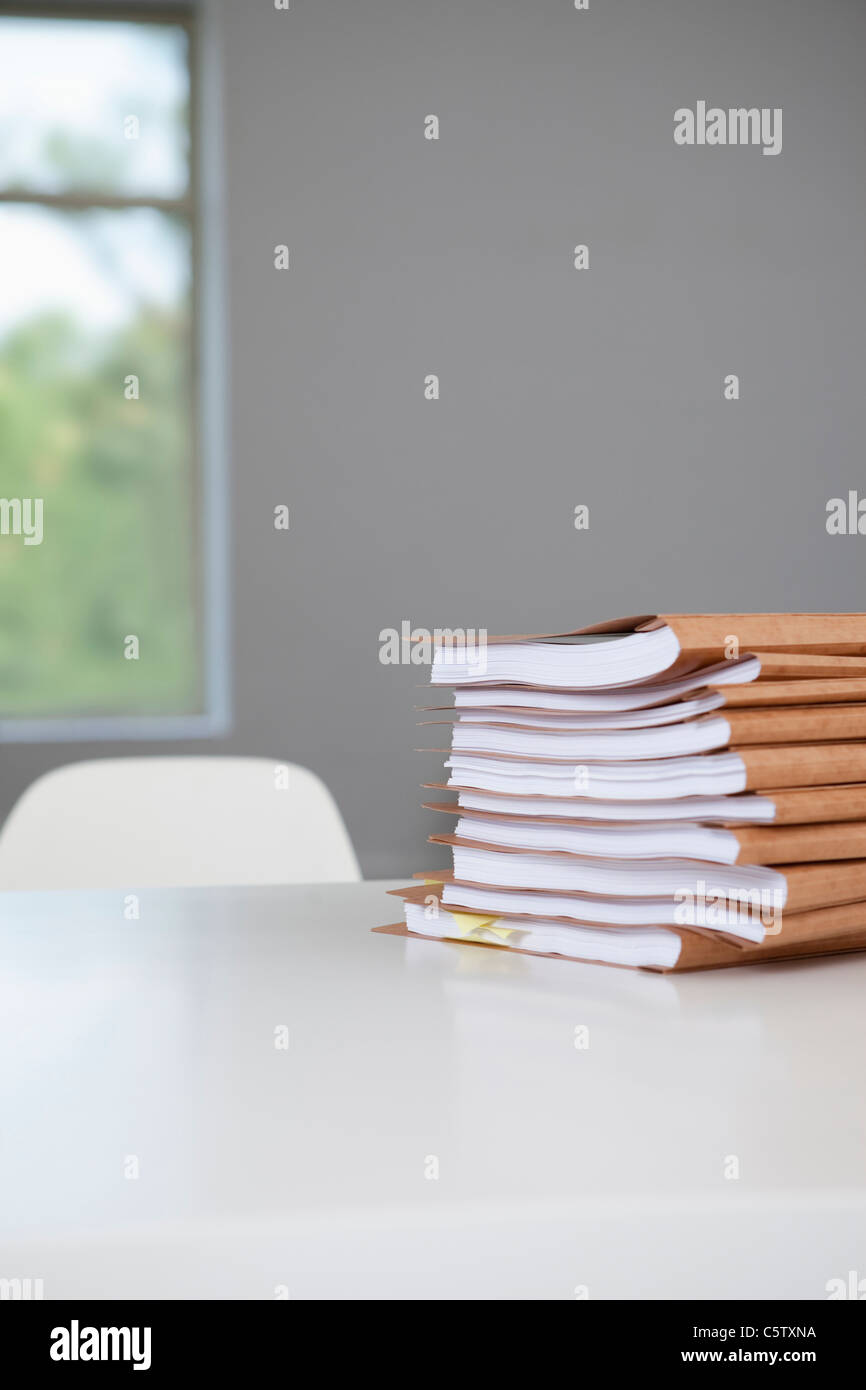 Stack of files in conference room Stock Photo - Alamy