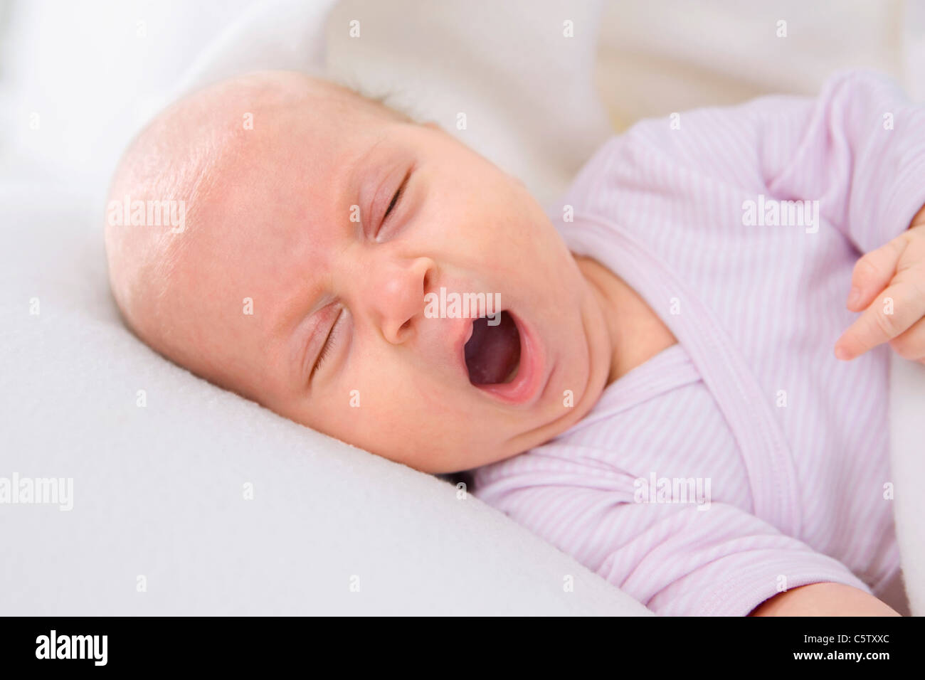 Baby girl (2 months) yawning, portrait Stock Photo - Alamy