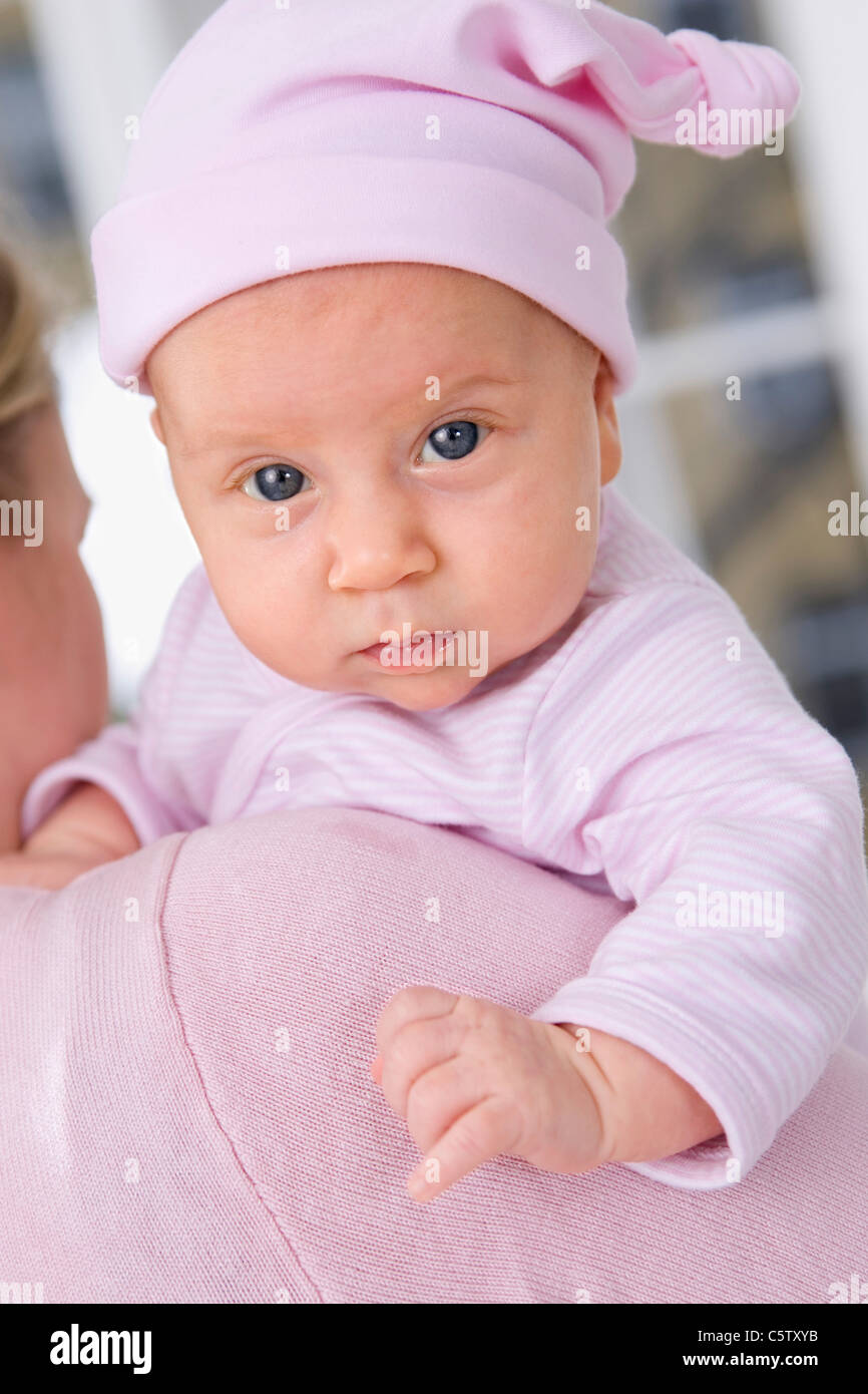 Baby girl (2 months) being carried, portrait Stock Photo - Alamy