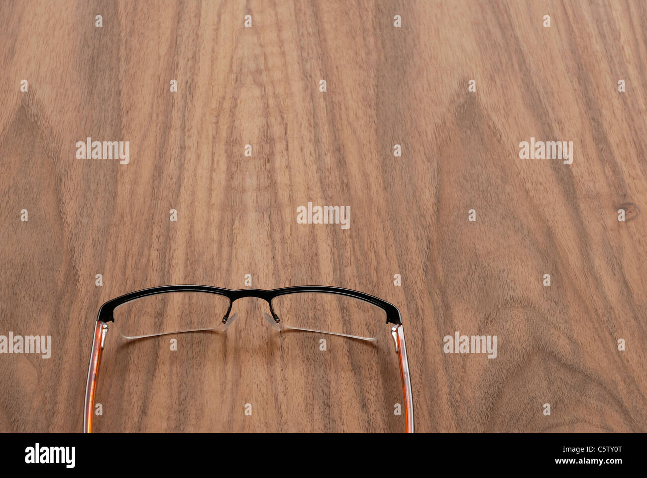 Spectacles on wooden table, elevated view Stock Photo - Alamy
