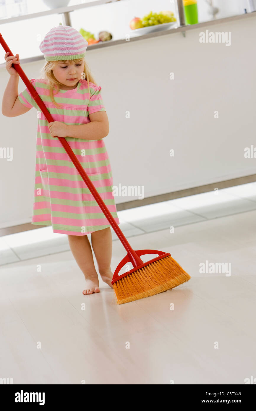 Little girl (4-5) playing with broom Stock Photo - Alamy