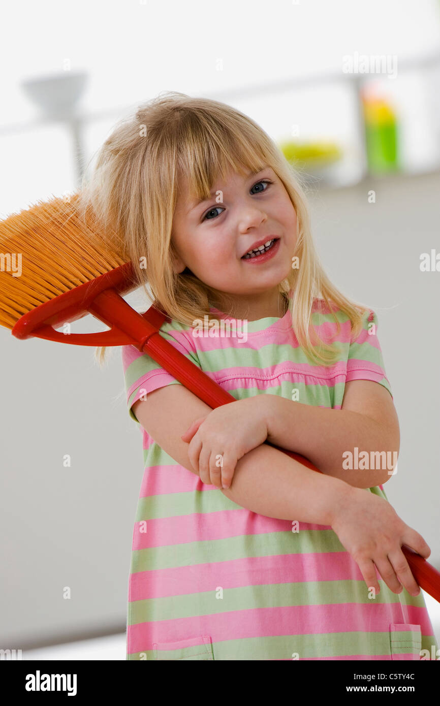 Little girl (4-5) playing with broom, portrait, close-up Stock Photo ...