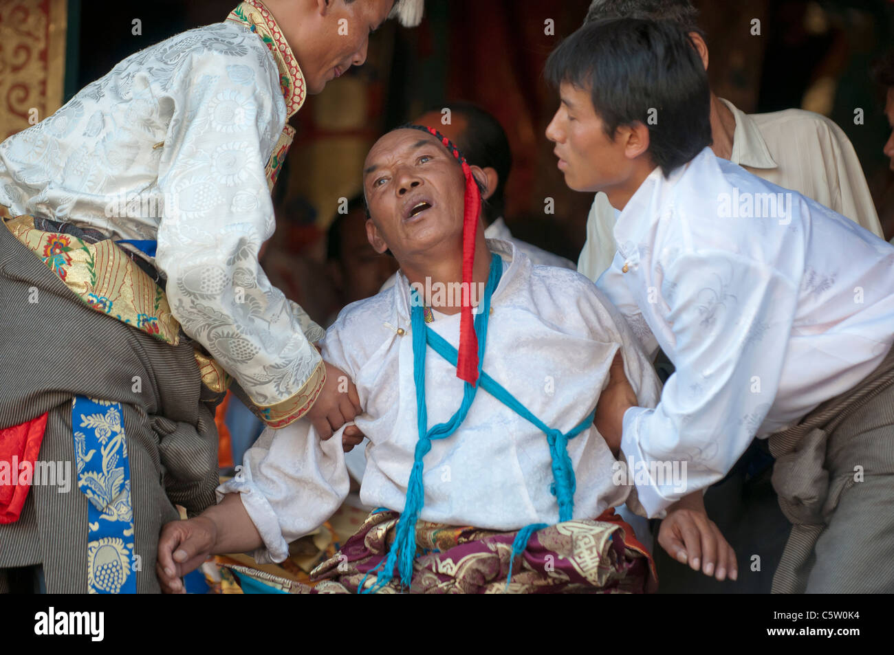 Village shaman in trance at climax of temple harvest festival, Tongren ...