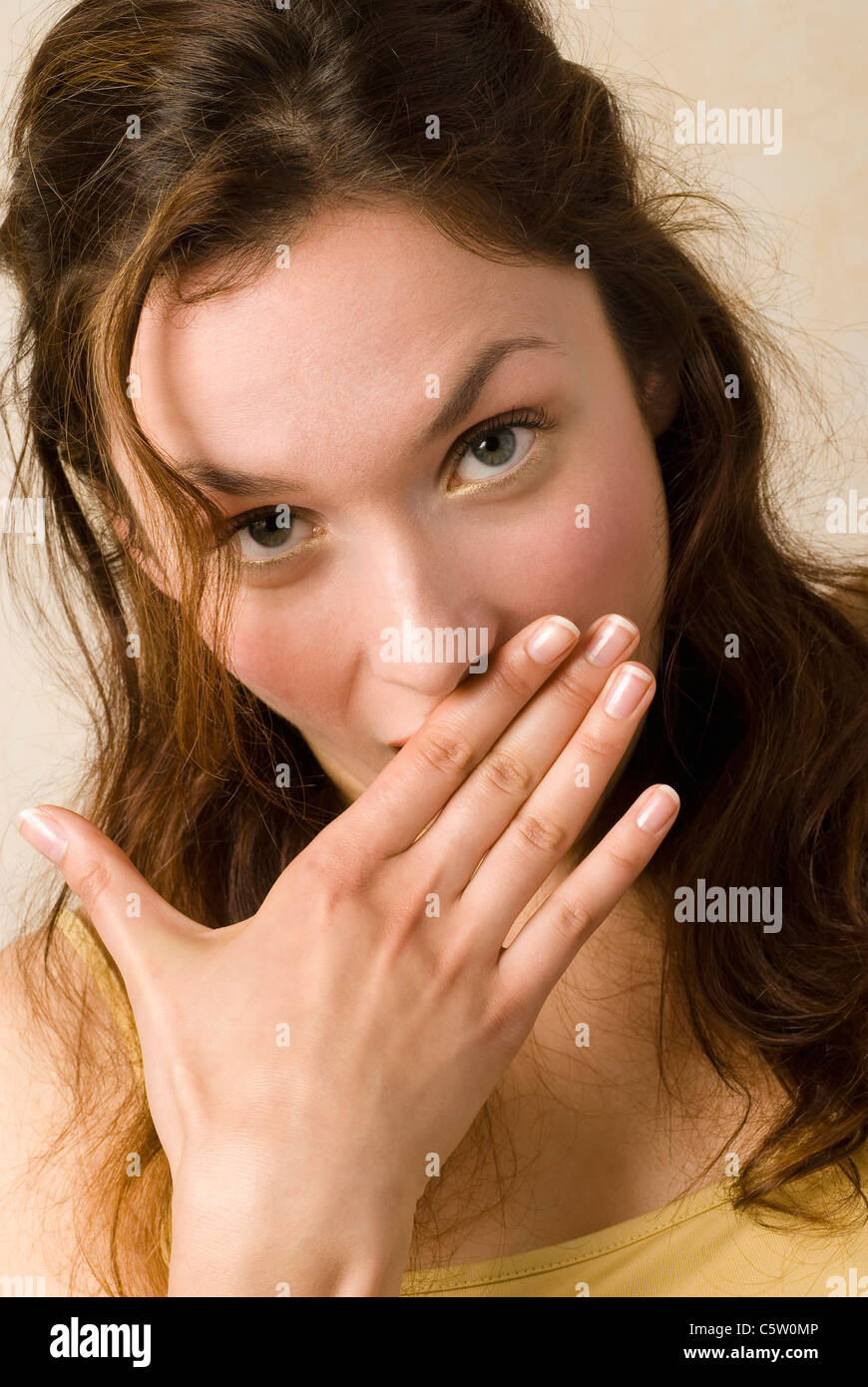 Young woman, hand to mouth, portrait, close up Stock Photo - Alamy