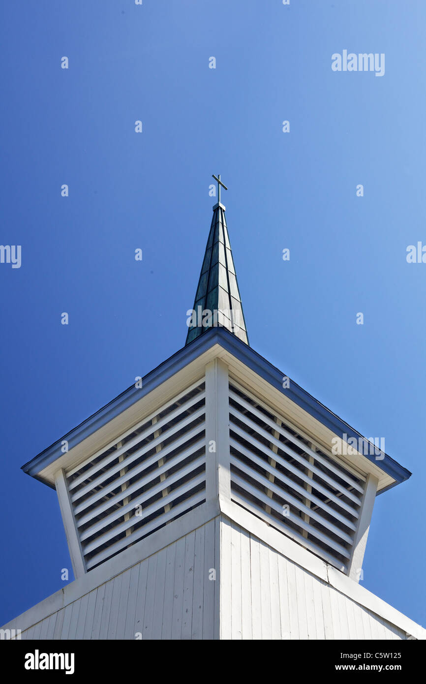An oblique view of the base and tip of a blue and white church steeple ...