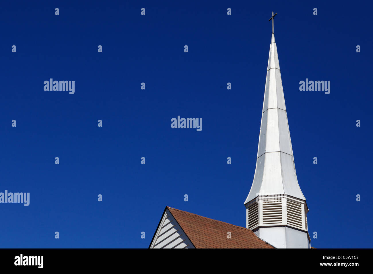 Thin pointy metal church steeple against a dark blue sky Stock Photo ...