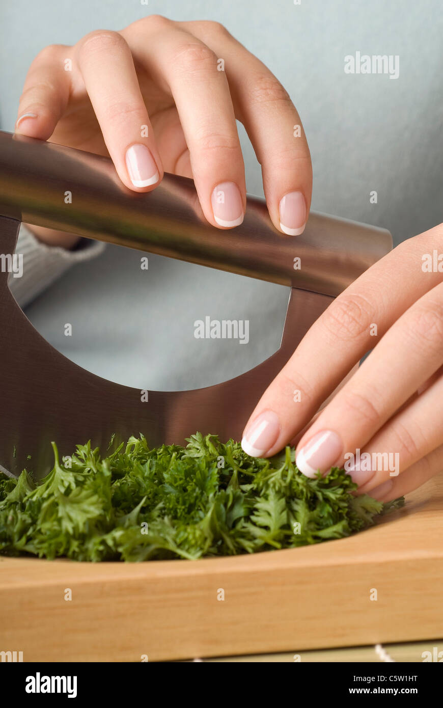 Person cutting parsley, close-up Stock Photo - Alamy
