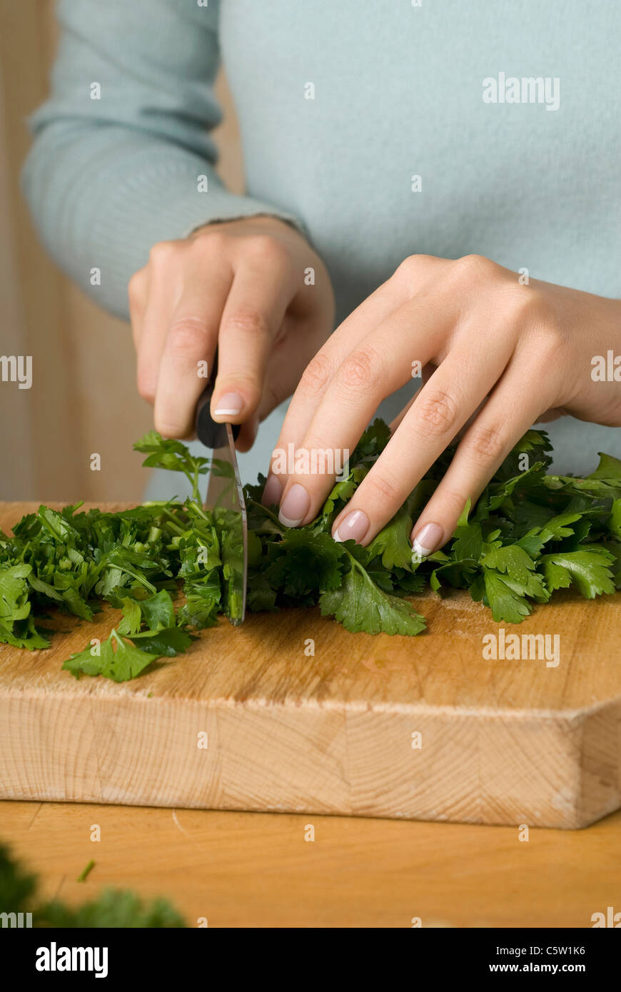 Person cutting parsley, close-up Stock Photo - Alamy