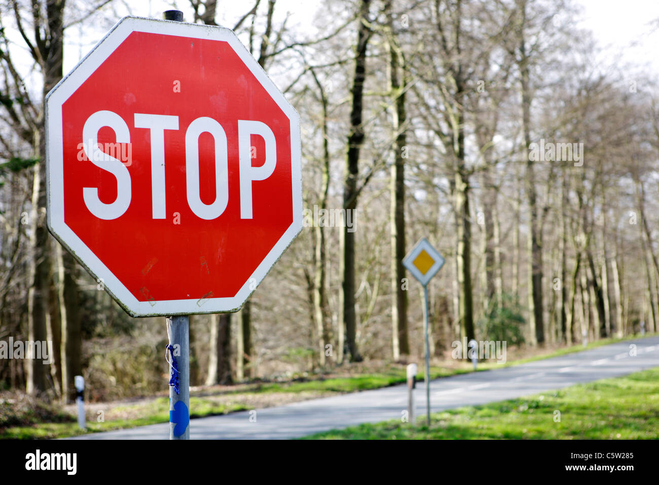 Stop sign on road, close-up Stock Photo - Alamy