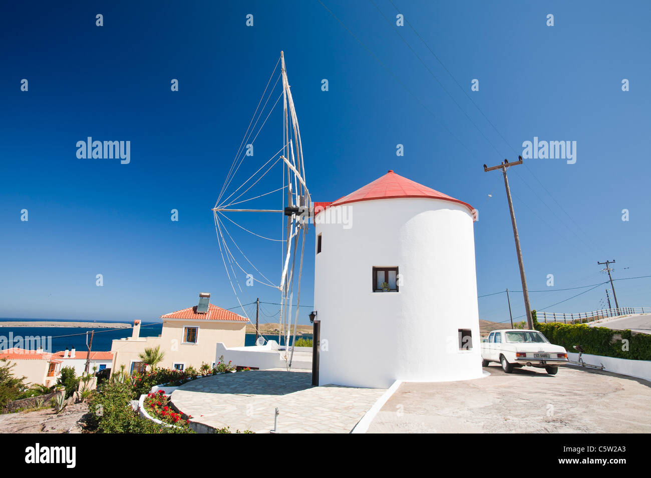 A traditional cloth sailed windmill converted into a house in Sigri, on ...