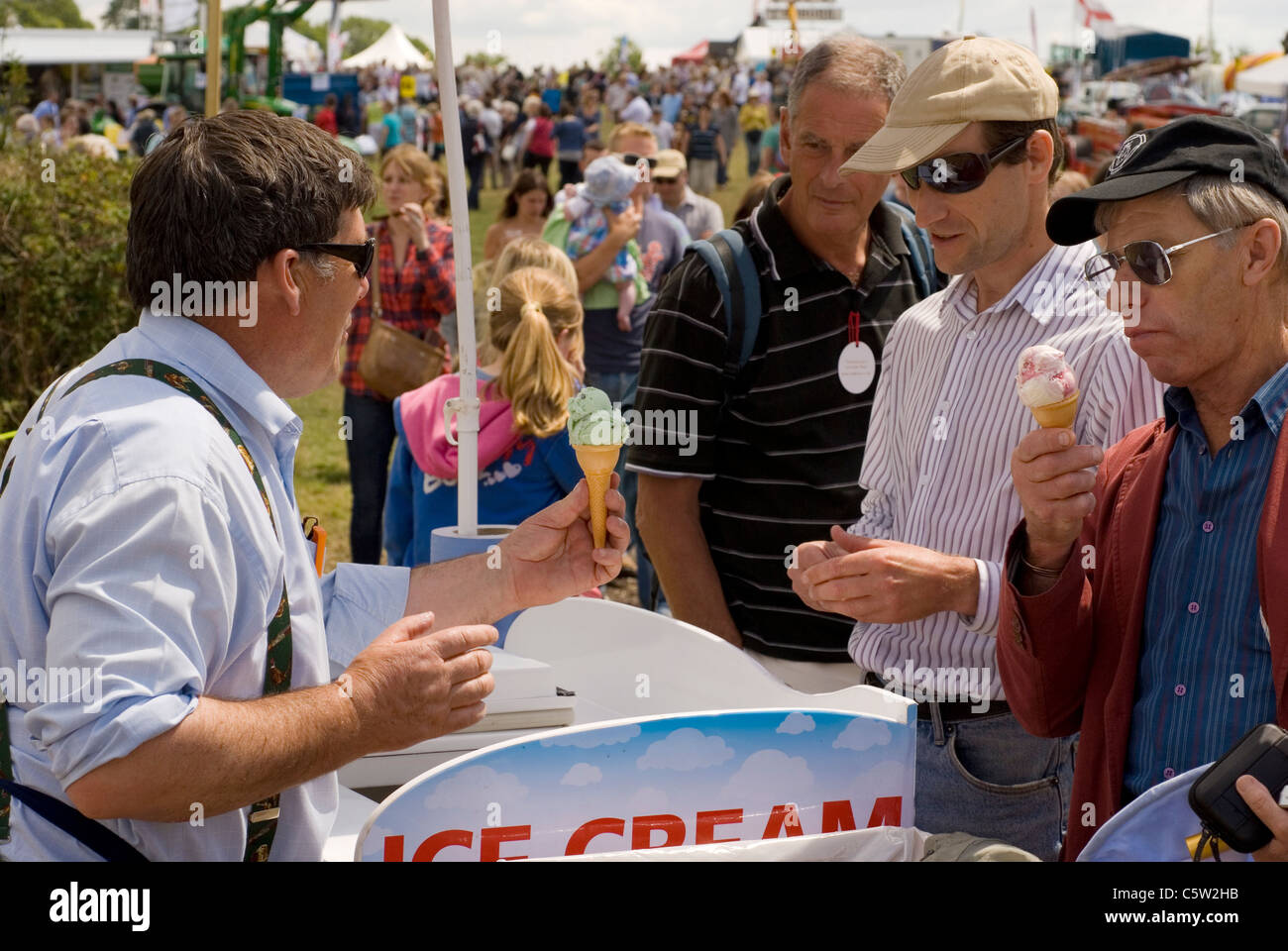 Mobile ice cream vendor serving ice cream to customers, England UK ...