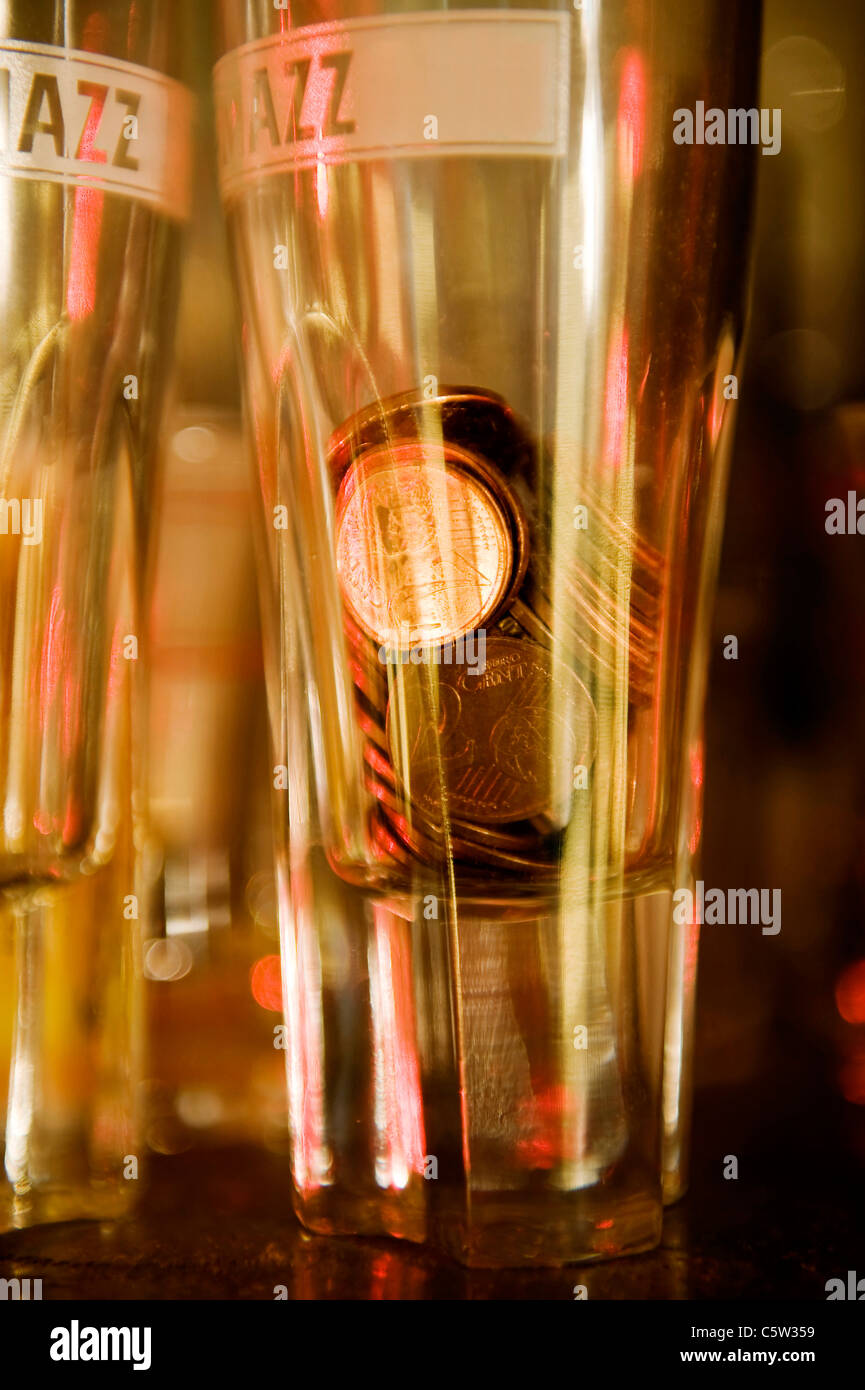 Coins in glass on bar counter Stock Photo - Alamy