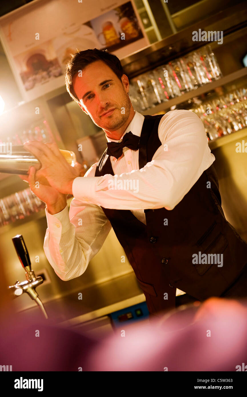 Barkeeper shaking cocktail mixer Stock Photo - Alamy