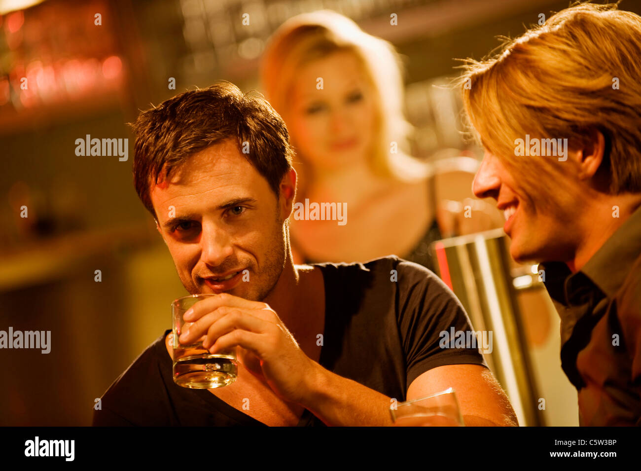 Two men in bar having drinks Stock Photo - Alamy