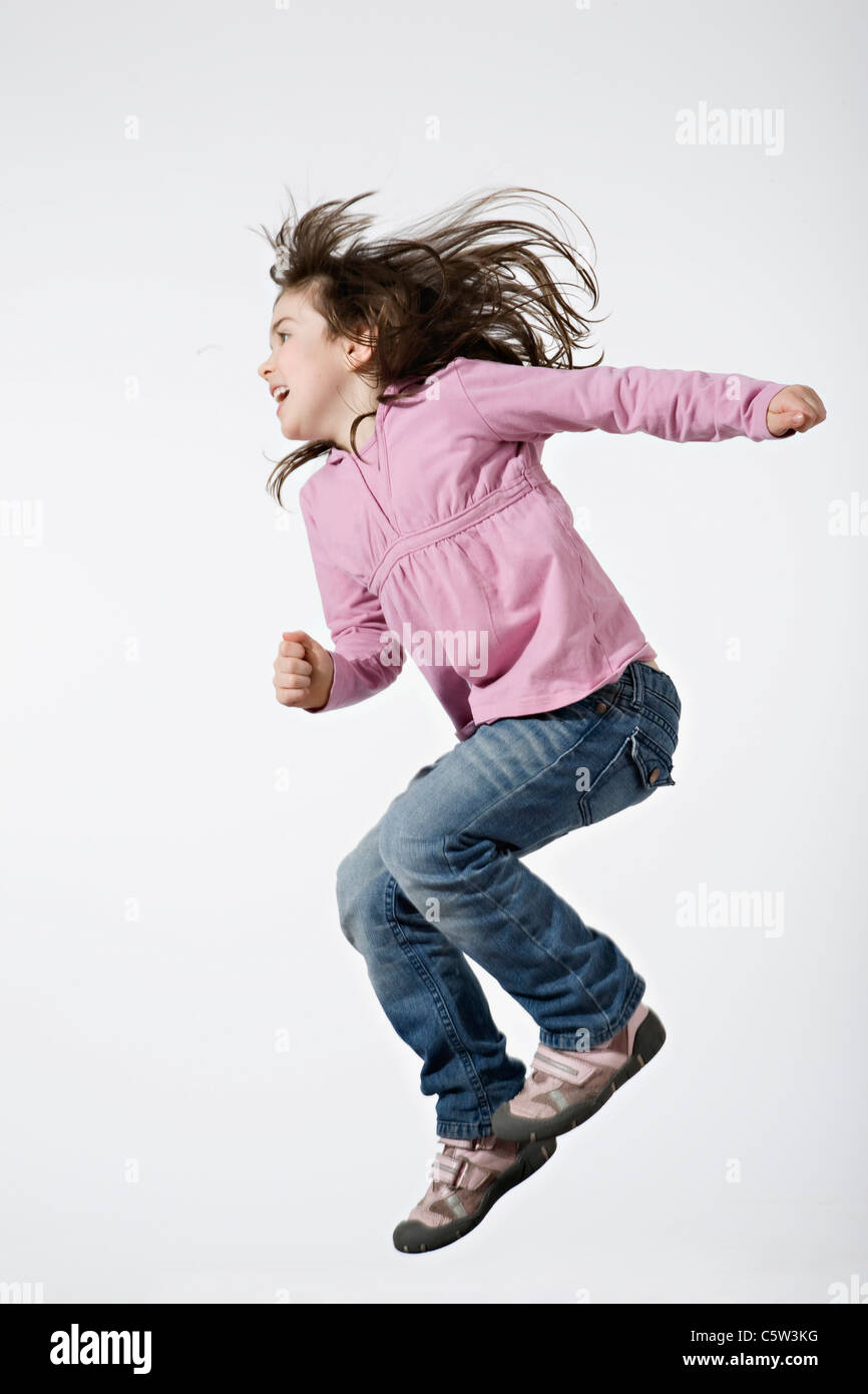 Girl (4-5) jumping, side view, portrait Stock Photo - Alamy