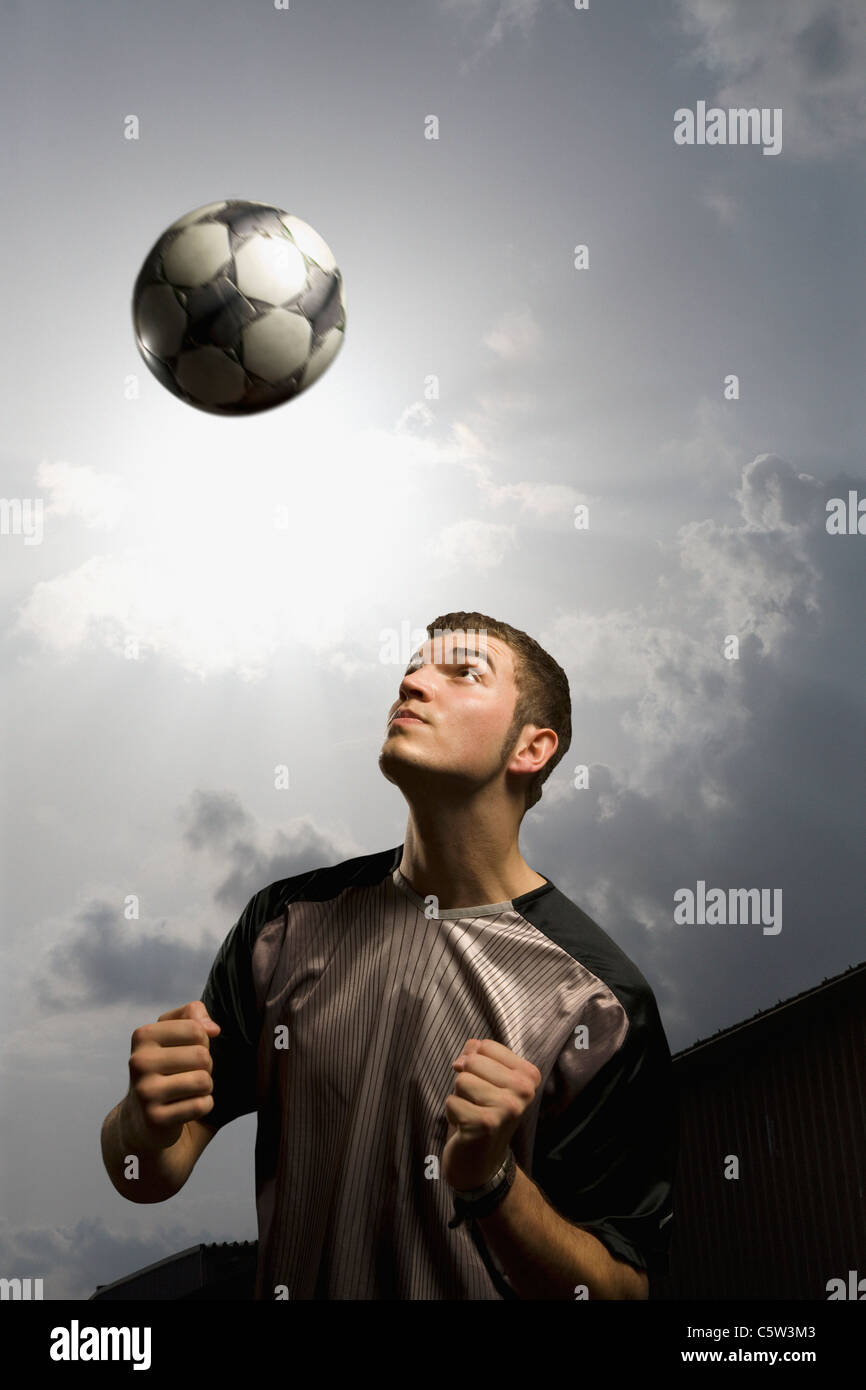 Man heading ball, portrait, close-up Stock Photo - Alamy