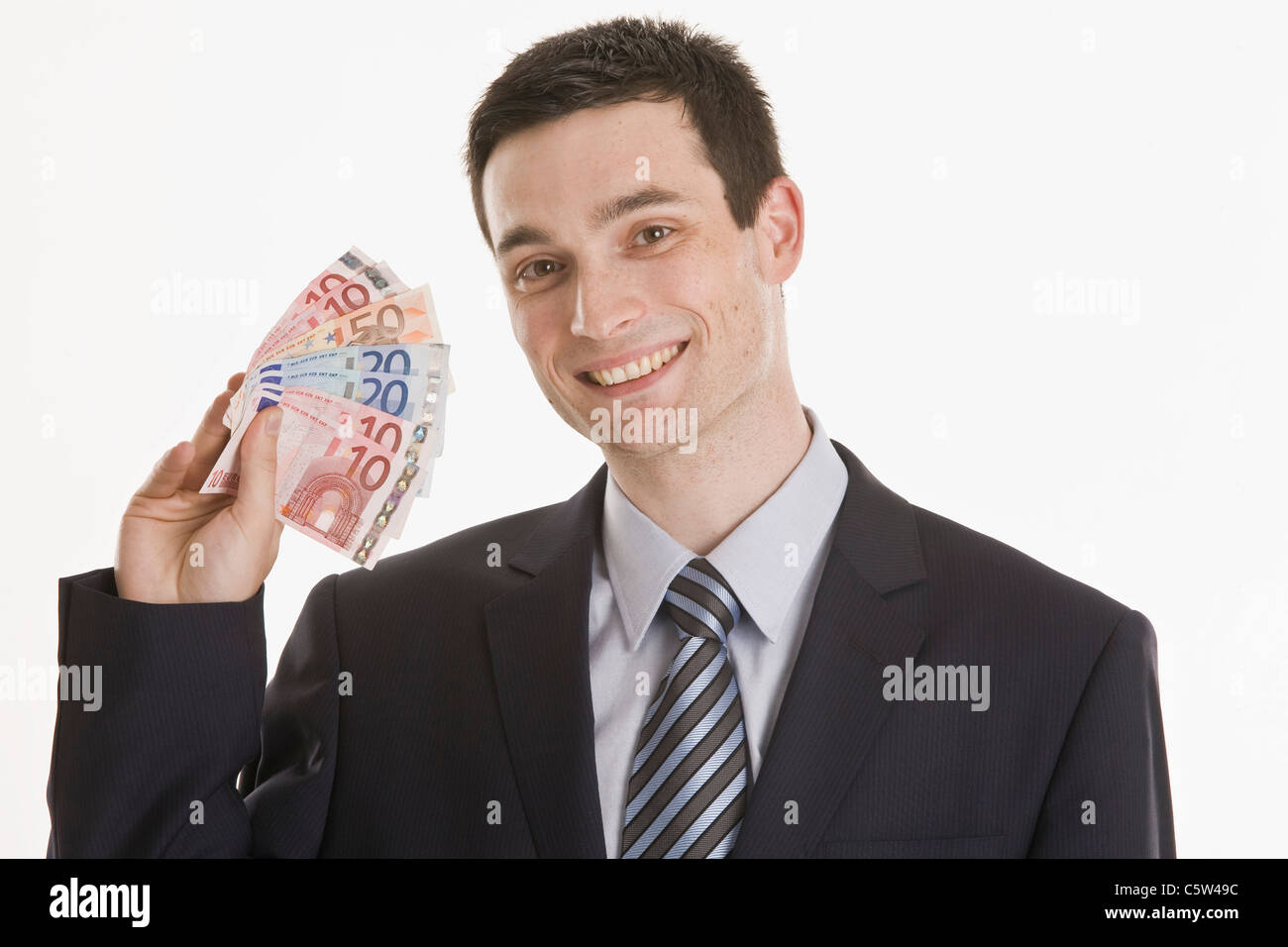 Businessman holding banknote making hi-res stock photography and images ...