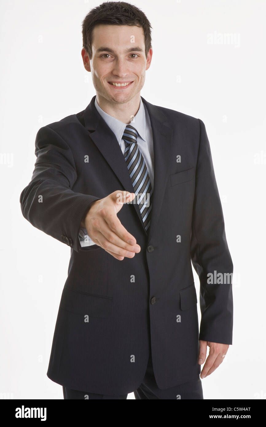 Businessman putting forth his hand, smiling, portrait Stock Photo - Alamy