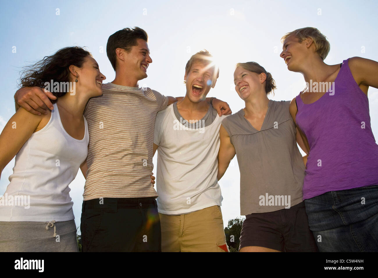 Germany, Bavaria, Young people embracing, laughing, portrait, close-up ...