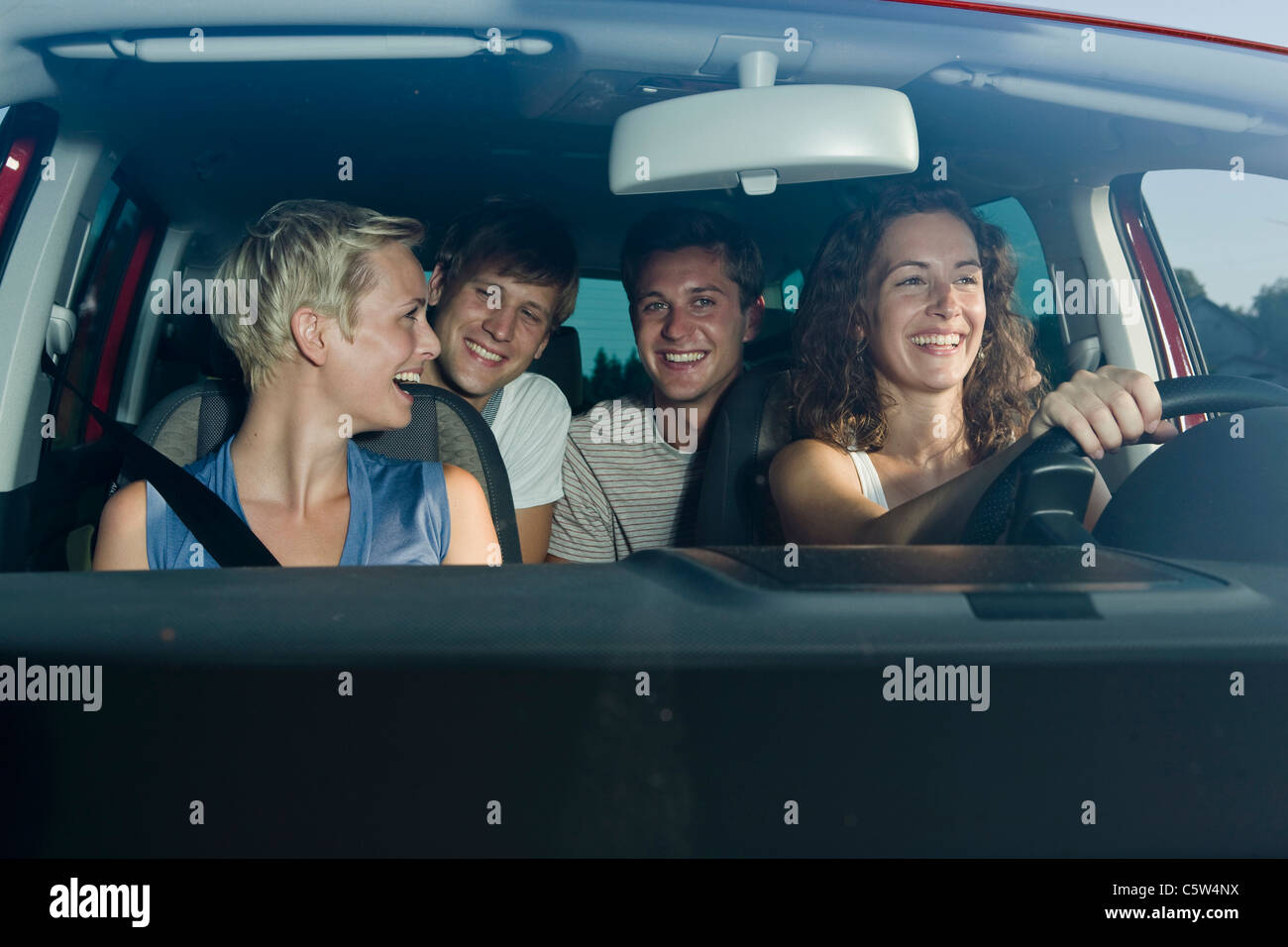 Germany, Bavaria, Young people driving car, smiling, portrait Stock ...