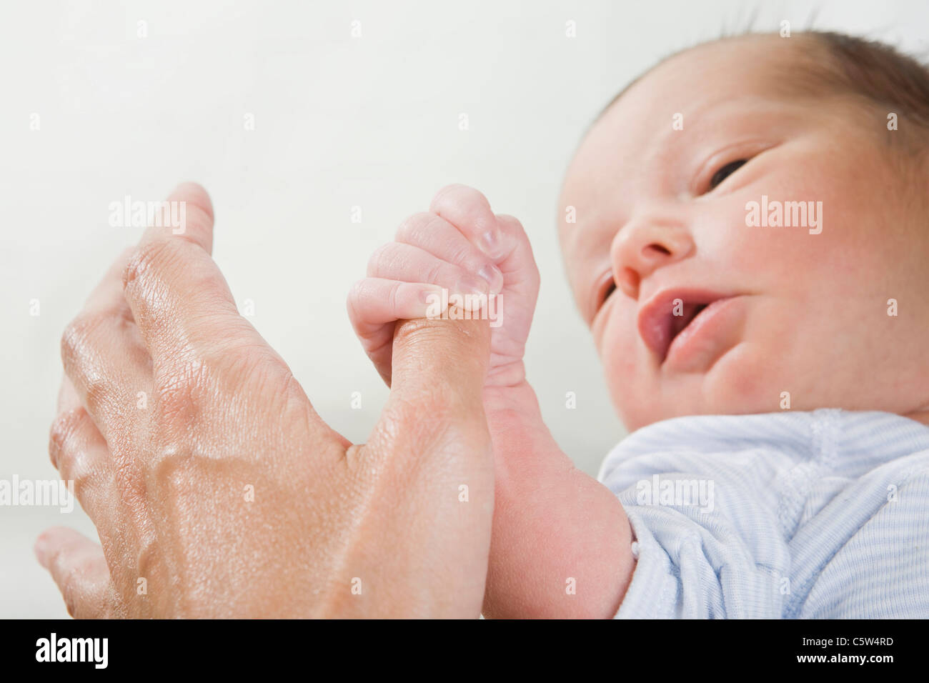 Baby holding adults finger hand hi-res stock photography and images - Alamy