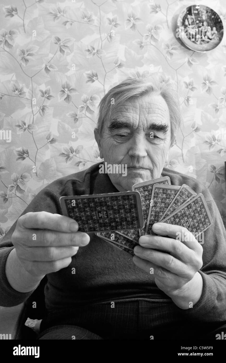 Senior man holding and playing cards Stock Photo - Alamy