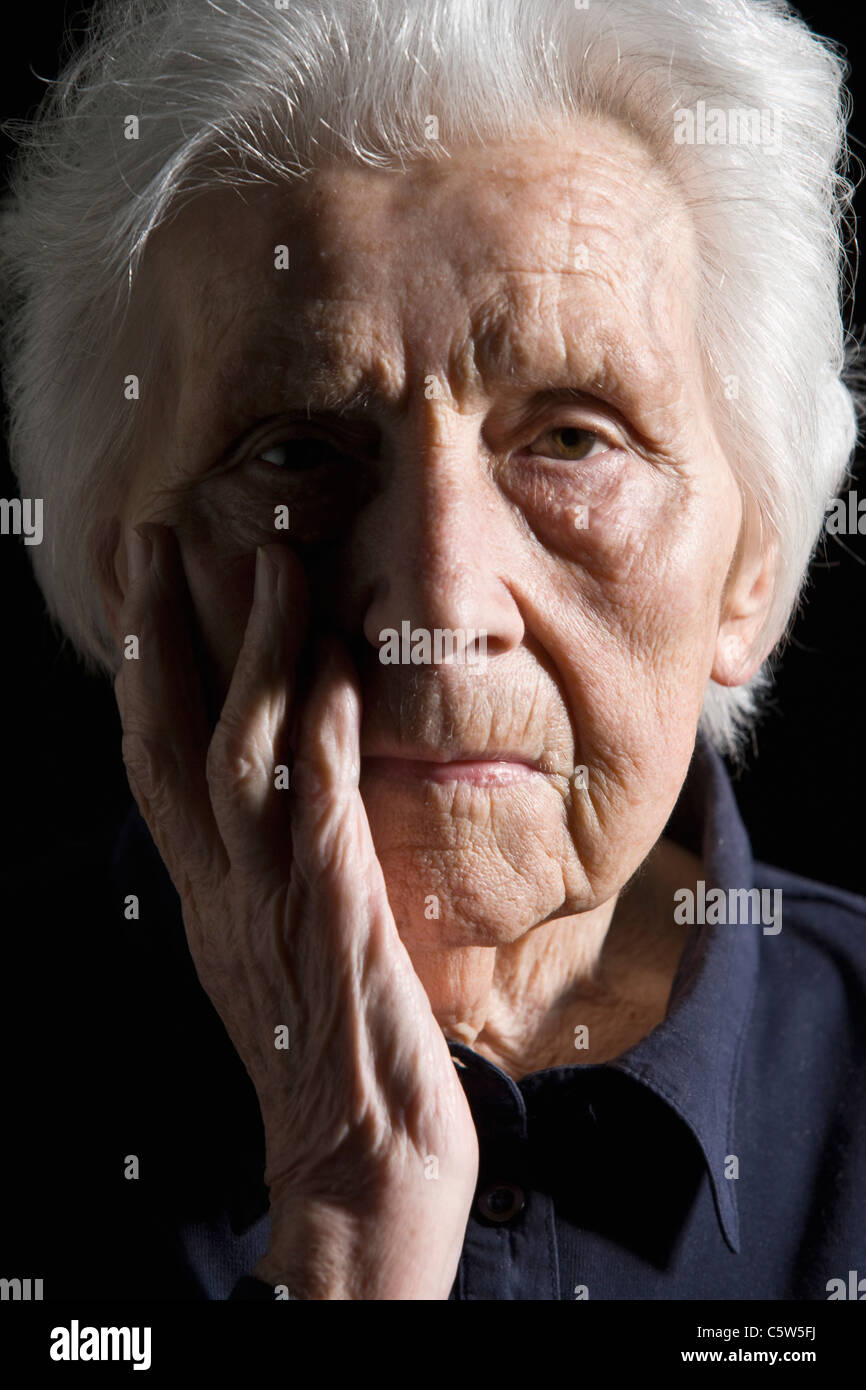 Senior woman with head in hand, portrait Stock Photo - Alamy