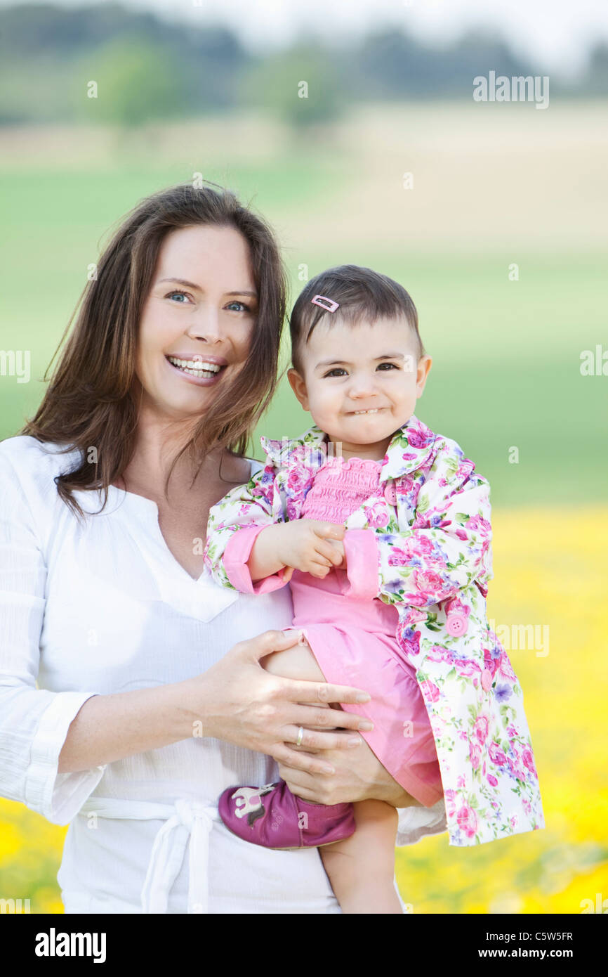 Germany, Bavaria, Mother holding baby girl, smiling Stock Photo - Alamy