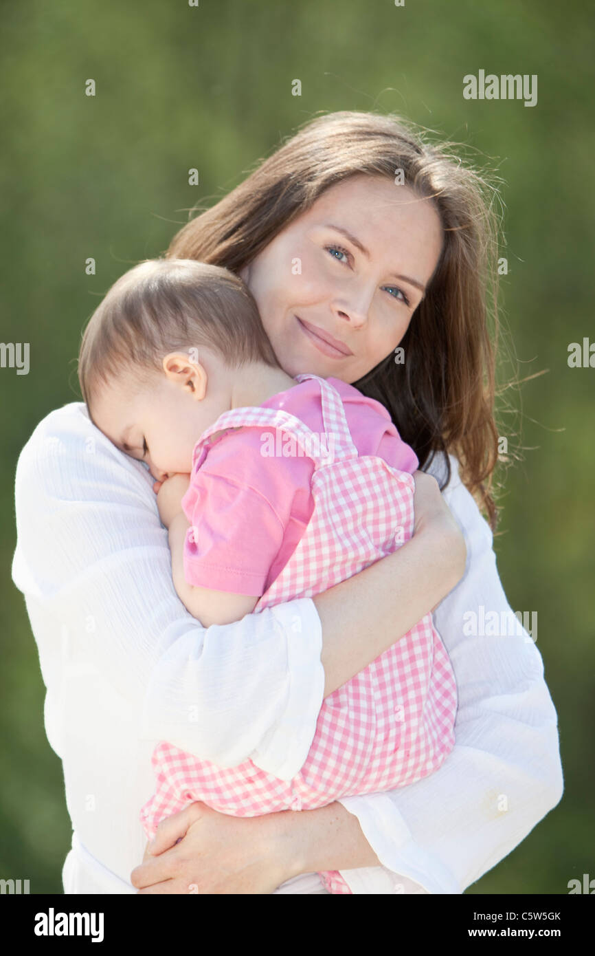 Germany, Bavaria, Mother embracing her baby girl, smiling Stock Photo ...