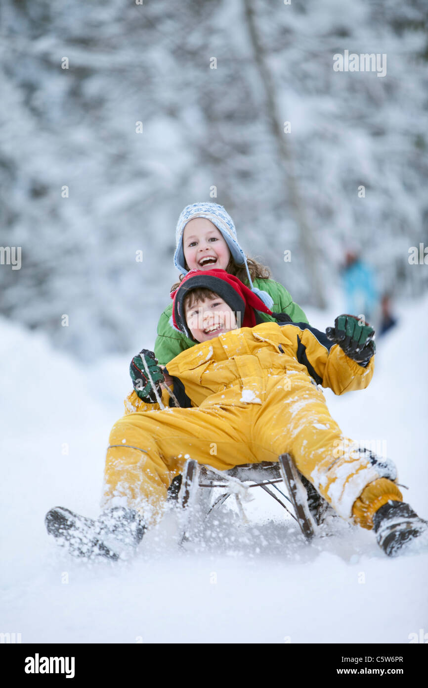 Boy girl sledding down snow hi-res stock photography and images - Alamy