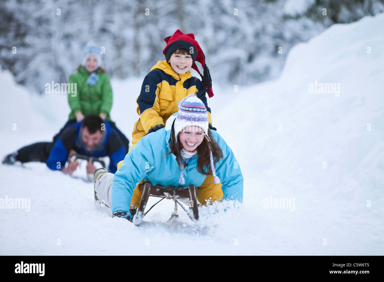 Germany, Bavaria, Family sledding, having fun Stock Photo - Alamy
