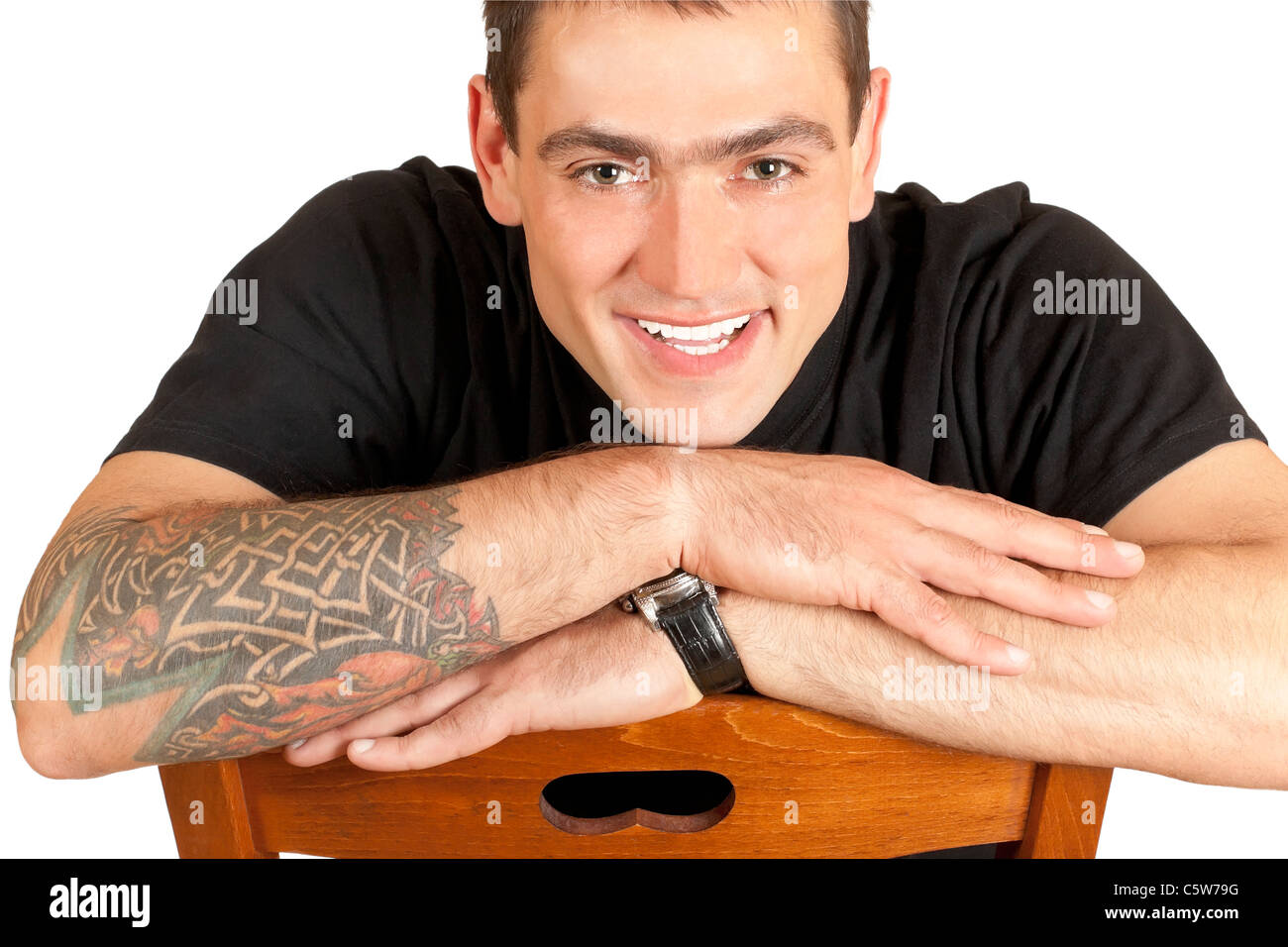 handsome young man sitting on a chair isolated on white background ...