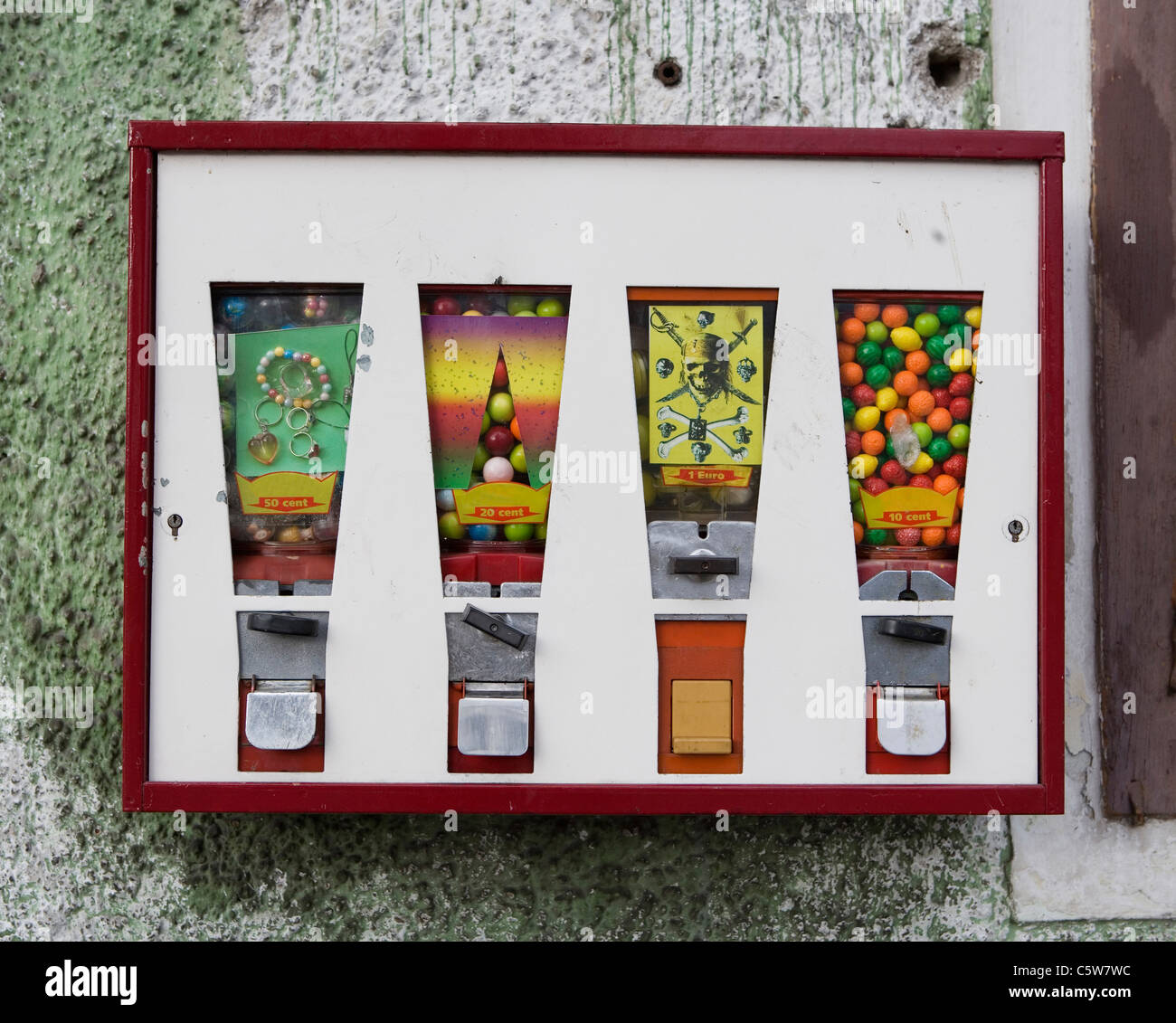Gumball machine at wall, close-up Stock Photo - Alamy