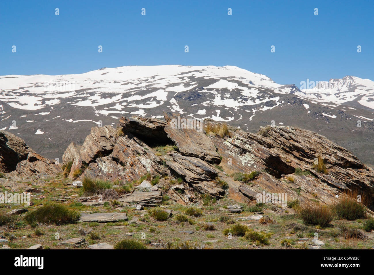 View of snow capped Sierra Nevada mountains from mountain footpath ...