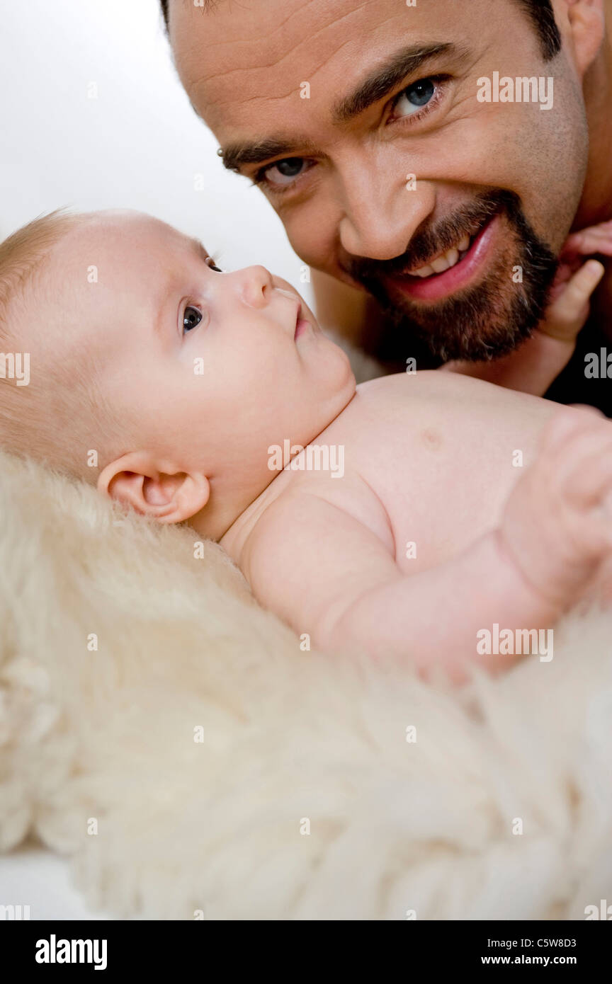 Man with baby boy (6-11 months), close-up Stock Photo - Alamy