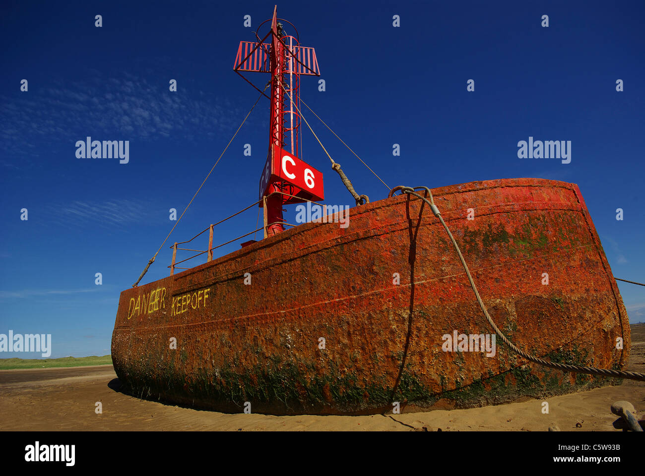 Old red boat stranded on Fornby beach, Merseyside Stock Photo - Alamy