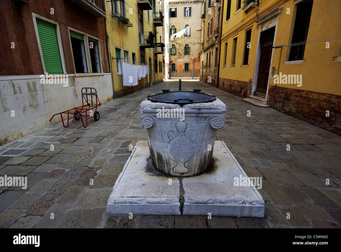 Ornate limestone well in Venice street featuring amphora Stock Photo ...