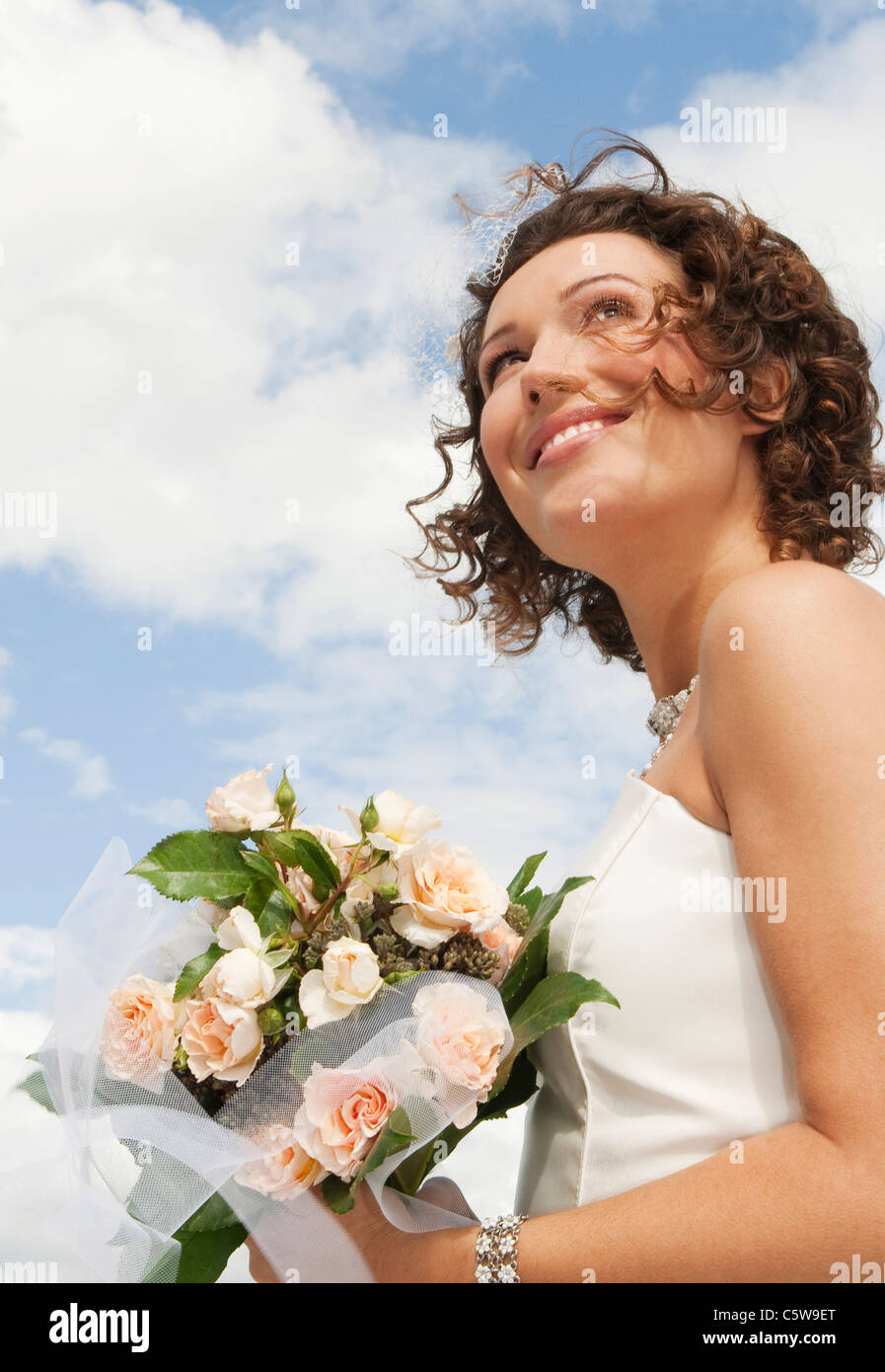 Germany, Bavaria, Smiling Bride with bouquet, outdoors, portrait, close ...