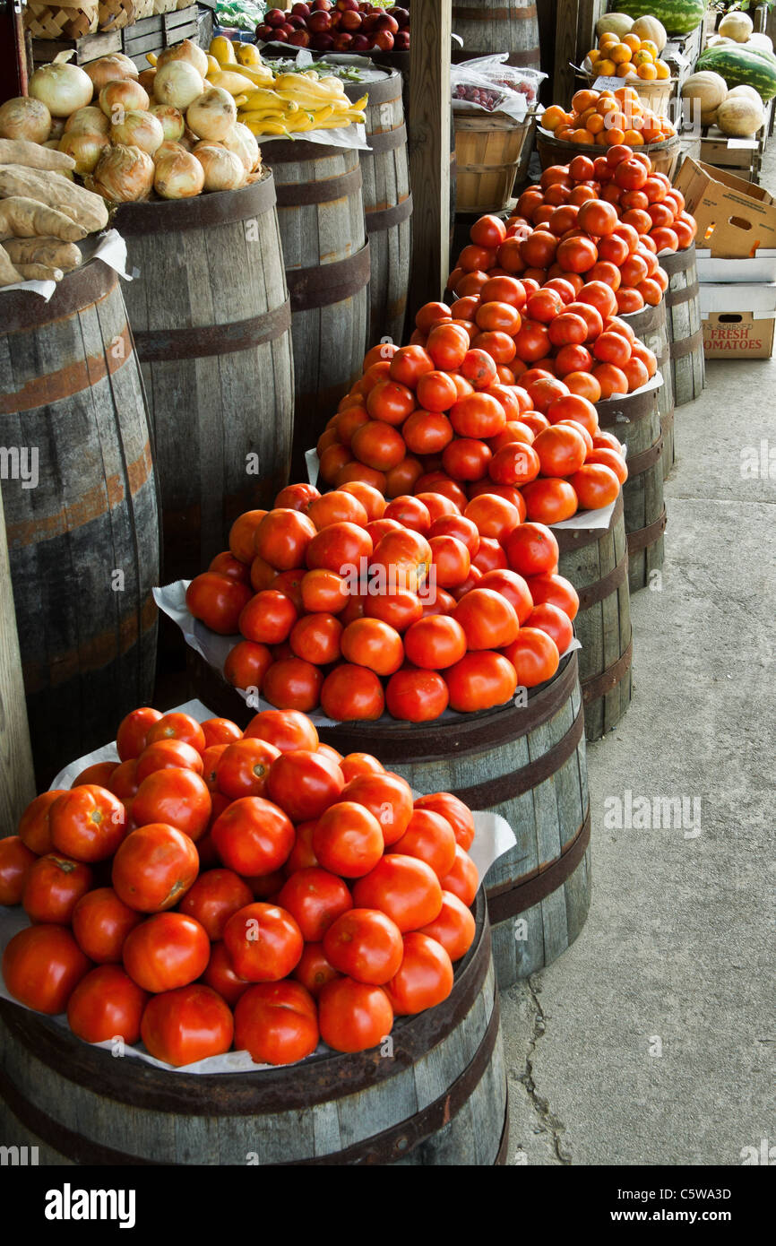 Fresh vegetables on display in barrels at a farmer's produce stand ...