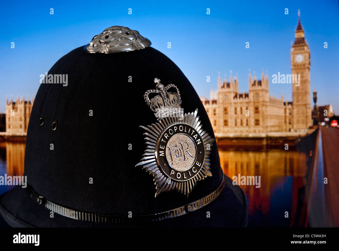 Metropolitan police helmet and badge with Houses of Parliament and ...