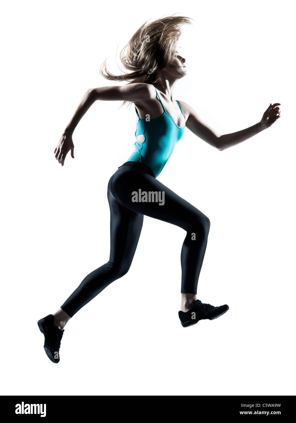 Side view of a beautiful fit and healthy blond woman running on white ...
