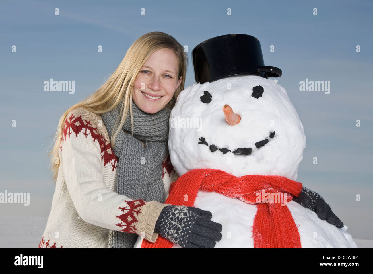 Germany, Bavaria, Munich, Woman hugging snowman Stock Photo - Alamy