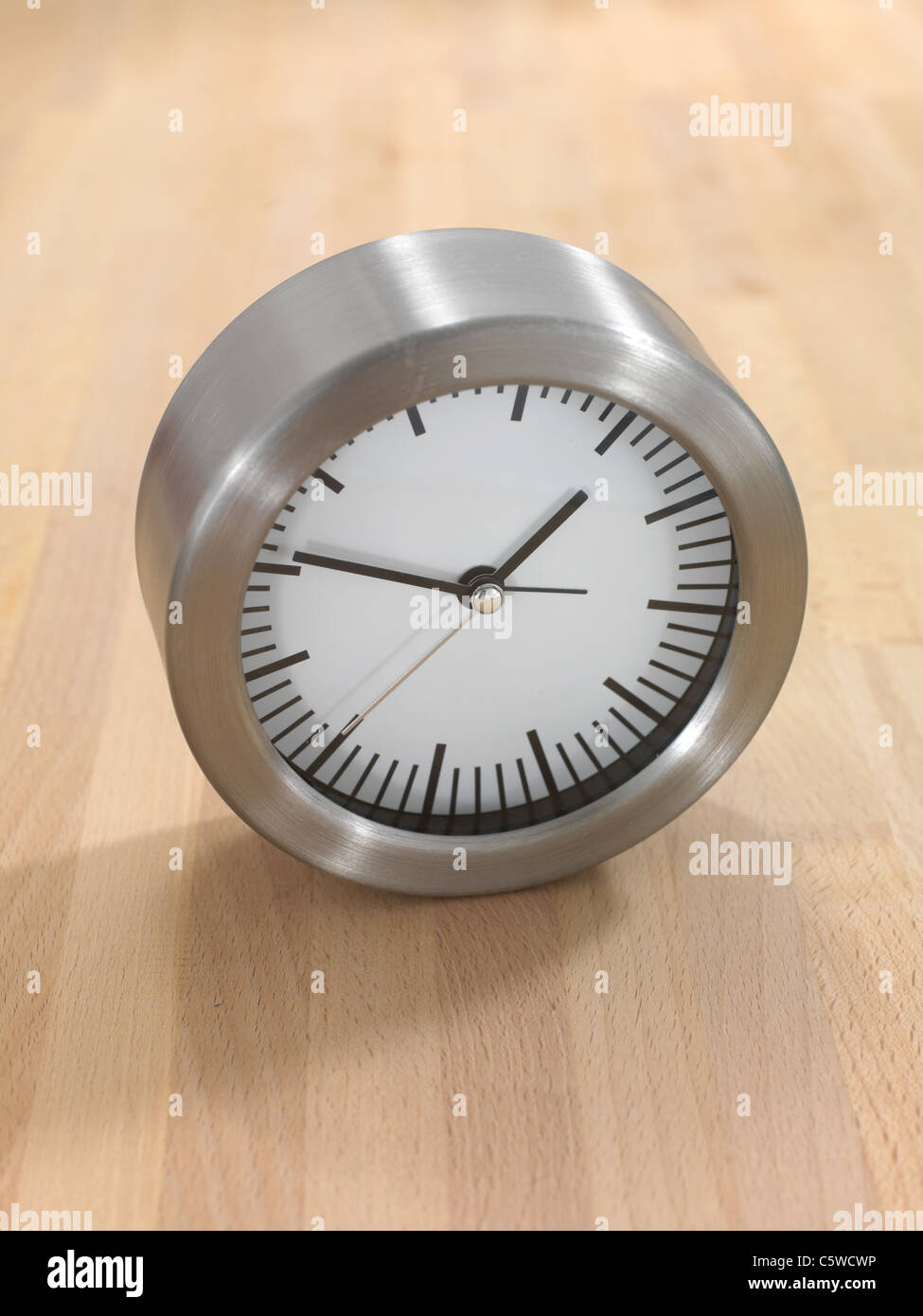 An analogue clock on a wooden bench Stock Photo - Alamy