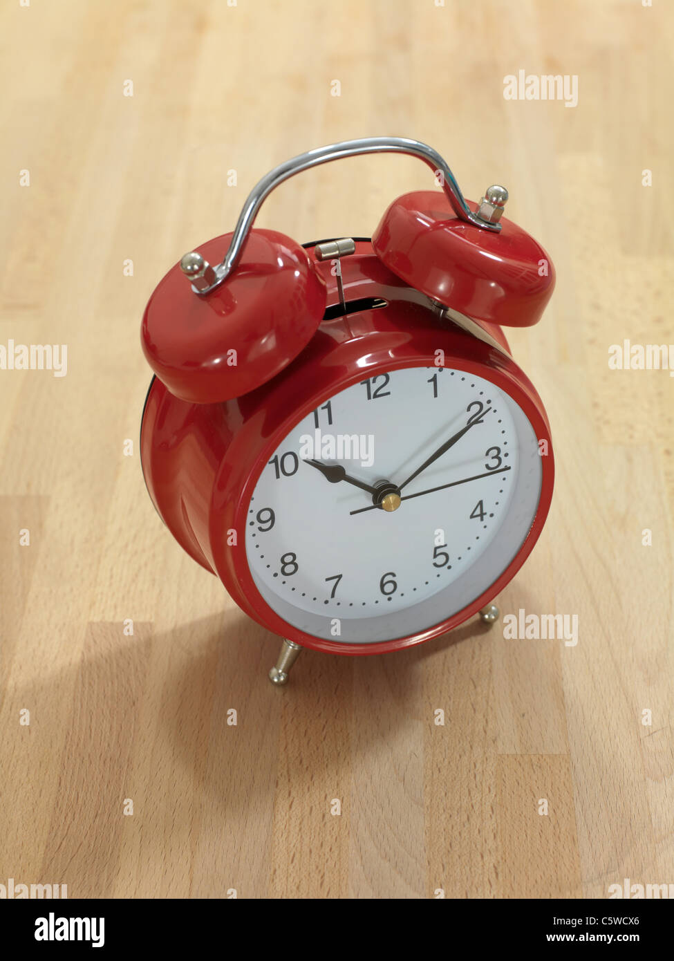 An analogue clock on a wooden bench Stock Photo - Alamy
