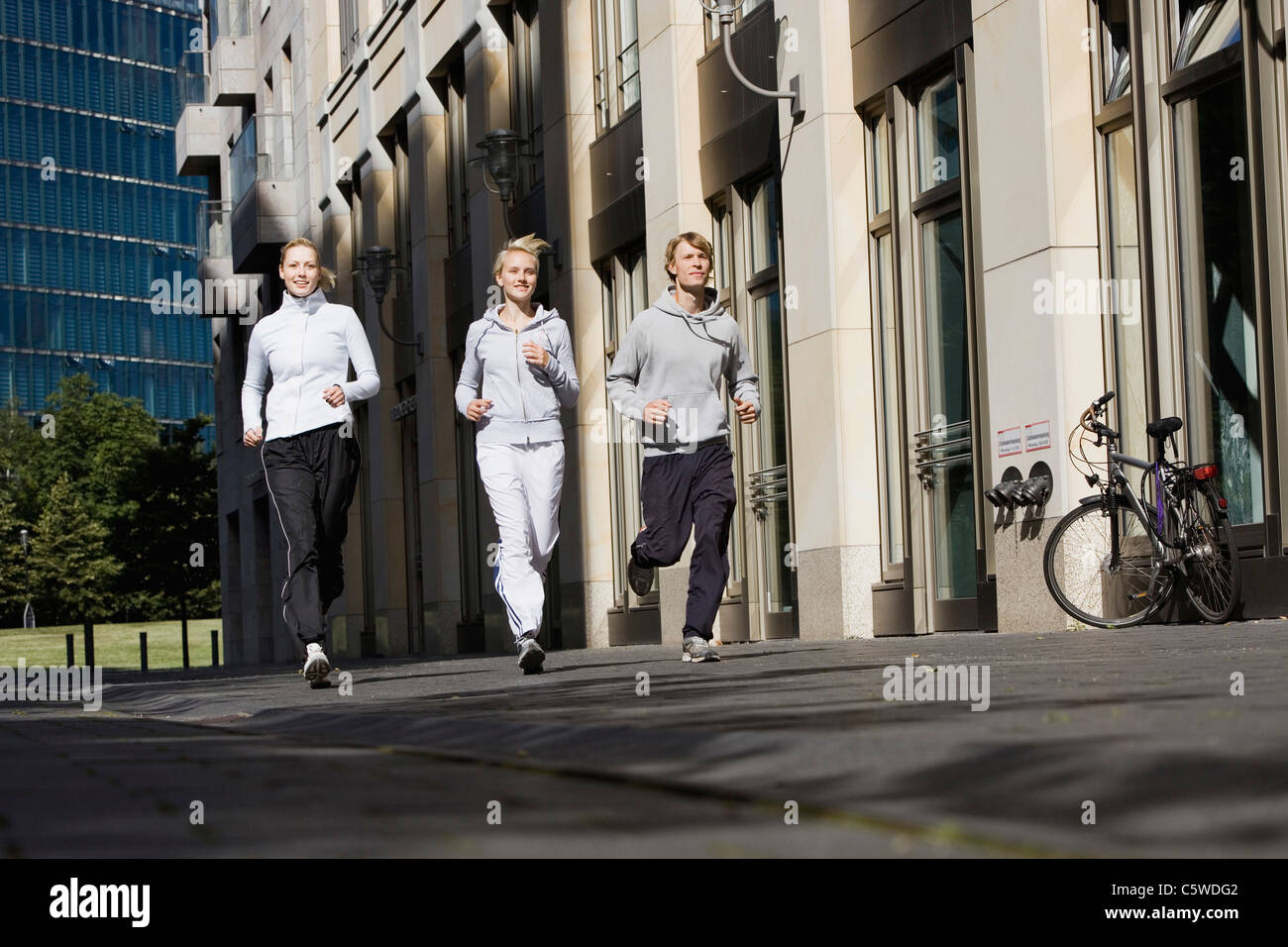 Three friends jogging together hi-res stock photography and images - Alamy